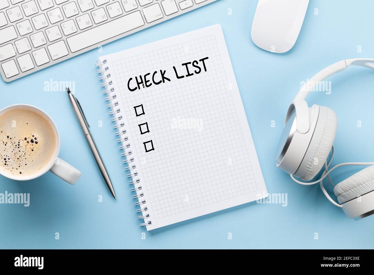 Office desk with supplies, coffee and notepad with check list ...