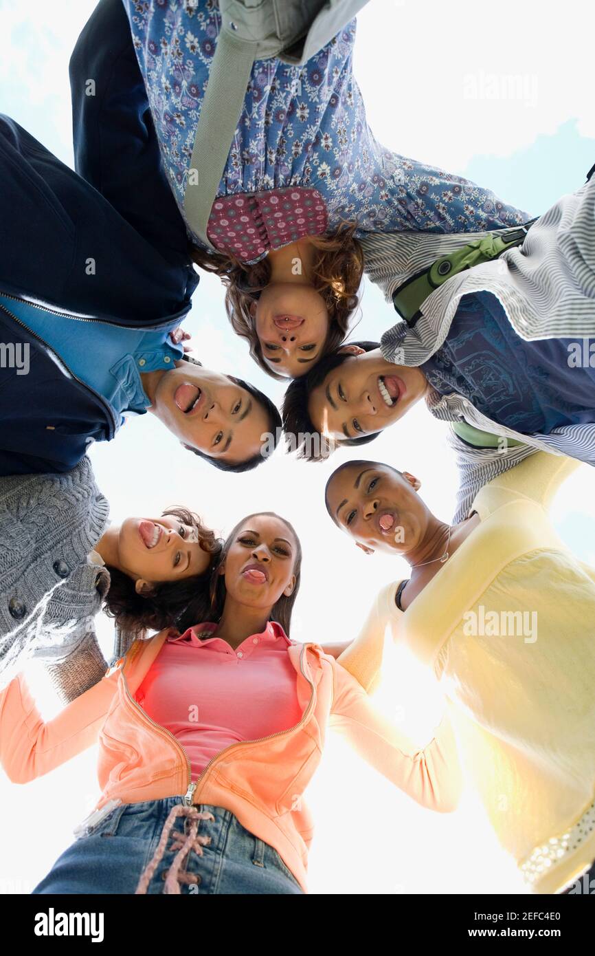 Low angle view of university students standing in a huddle Stock Photo ...