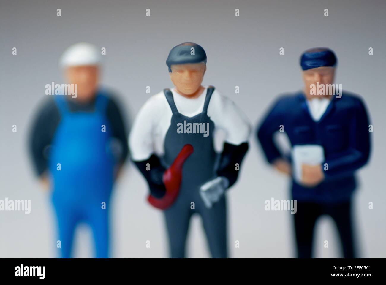 Close-up of three human figurines Stock Photo - Alamy