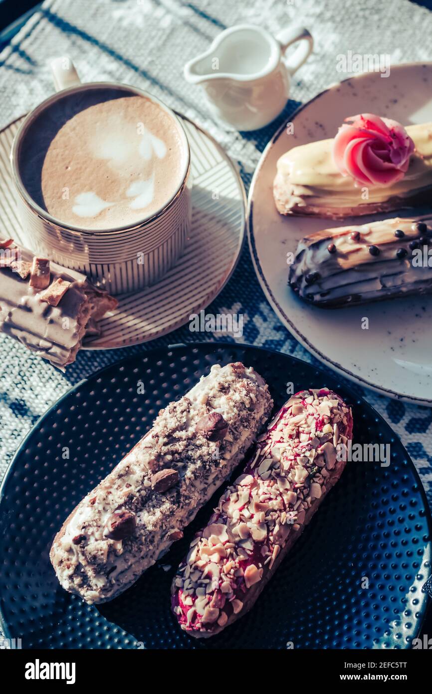 Vertical shot of traditional French eclairs with latte and milk Stock ...