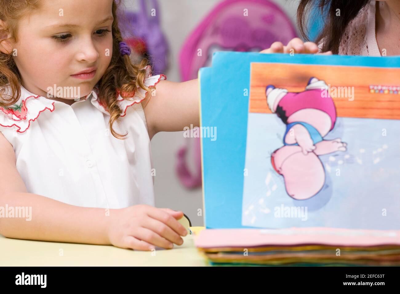 Girl looking at drawings Stock Photo - Alamy