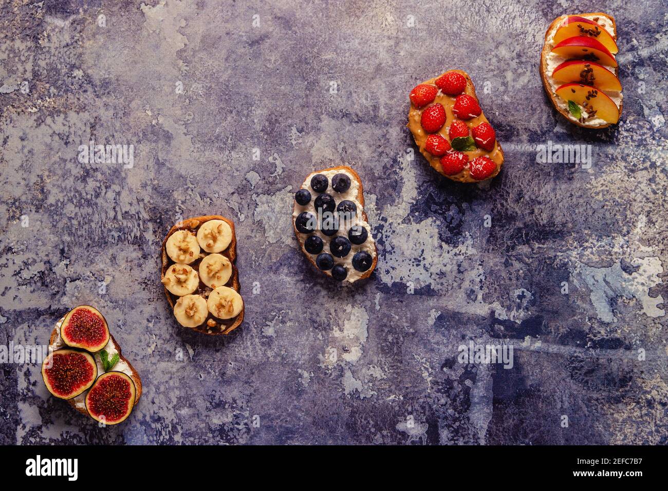 Homemade summer toast with cream cheese, nut butter and fruits and ...