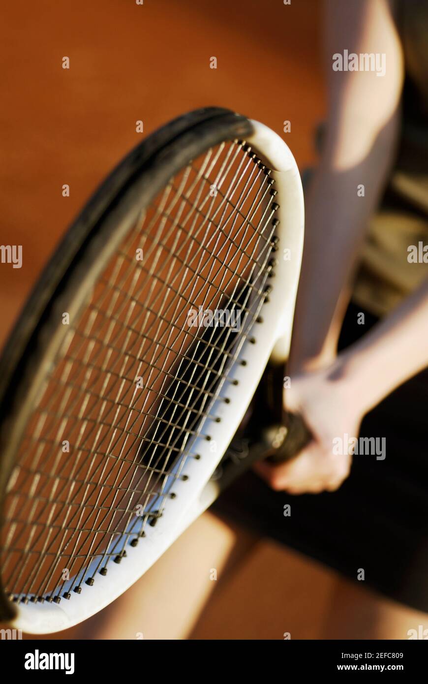 Mid section view of a woman holding a tennis racket Stock Photo - Alamy