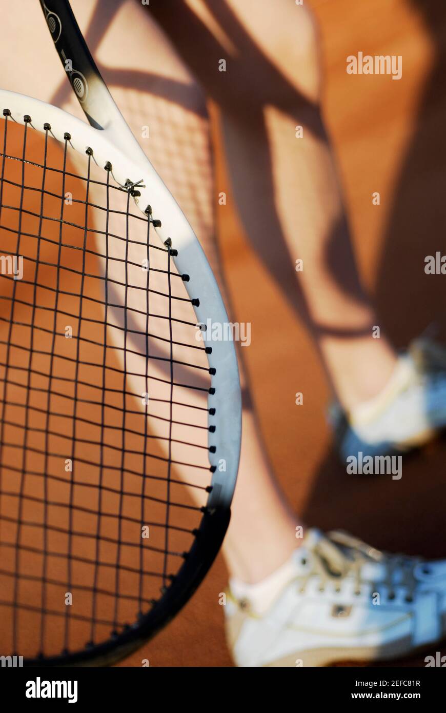 Low section view of a person with a tennis racket Stock Photo - Alamy