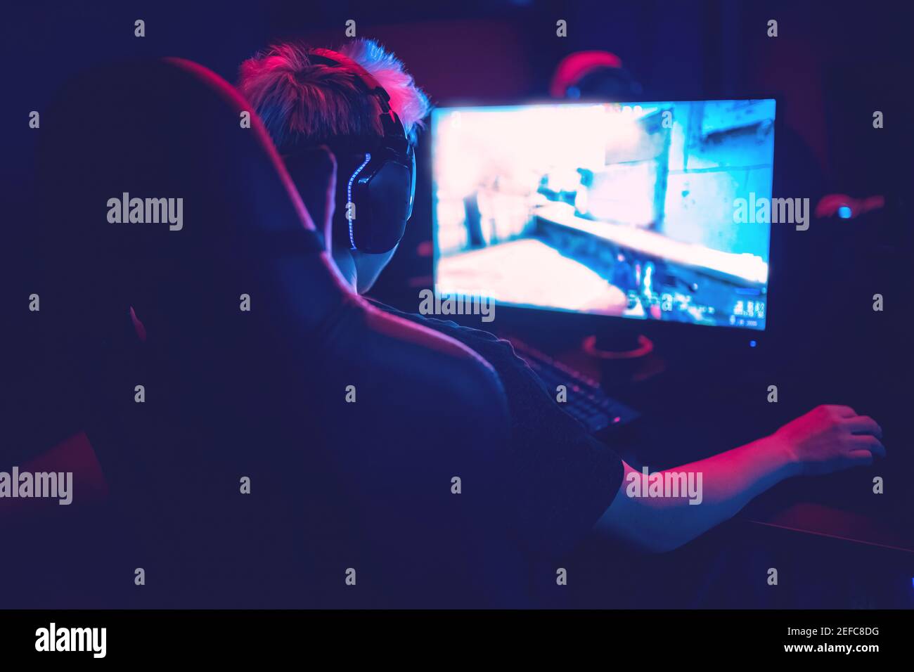 Professional gamer playing online games tournaments pc computer with ...