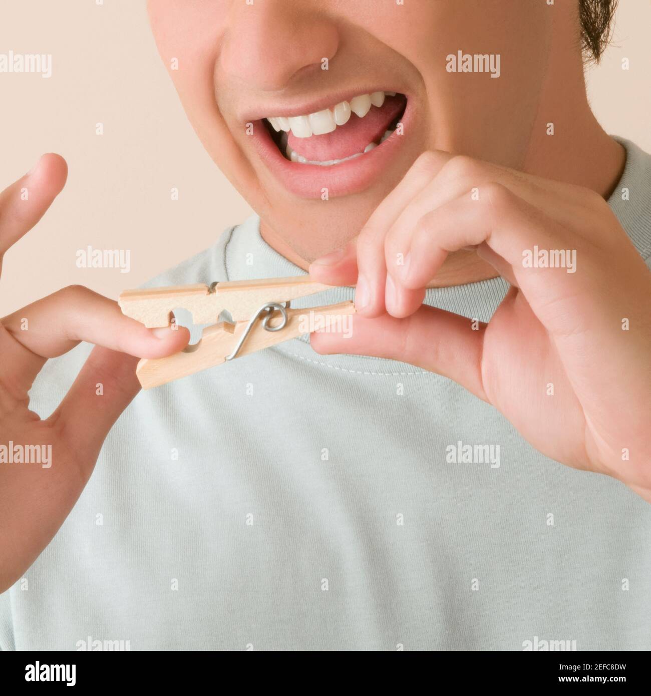 Close up of a young man pinching his finger with a clothespin Stock ...