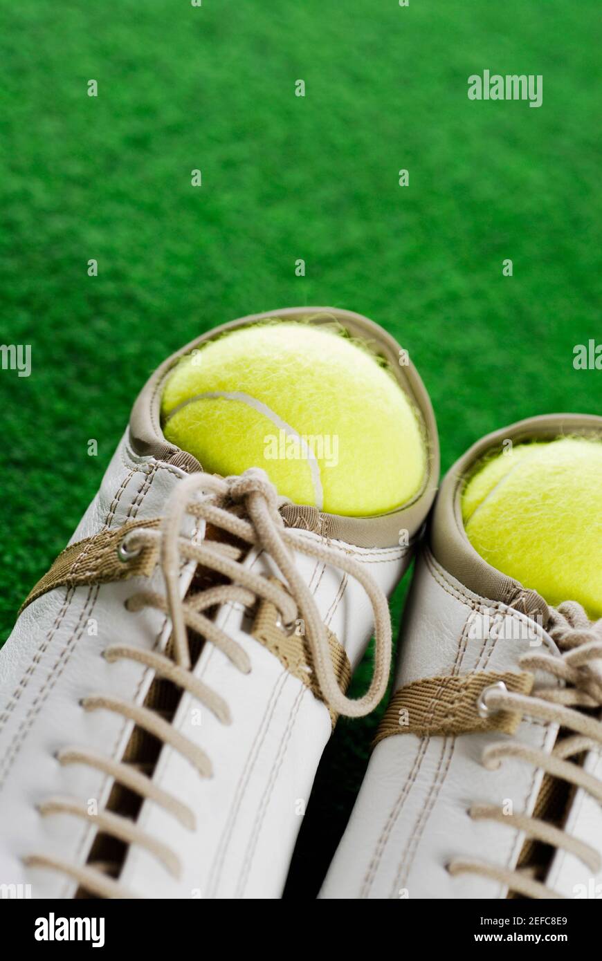 Close-up of two tennis balls in a pair of sports shoes Stock Photo - Alamy