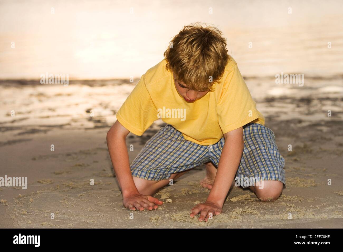 Boy Kneeling In Sand High Resolution Stock Photography and Images - Alamy