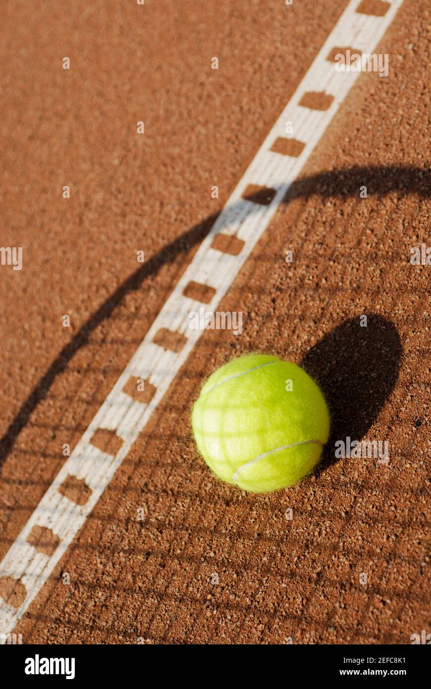 Shadow of a tennis racket over a tennis ball Stock Photo - Alamy
