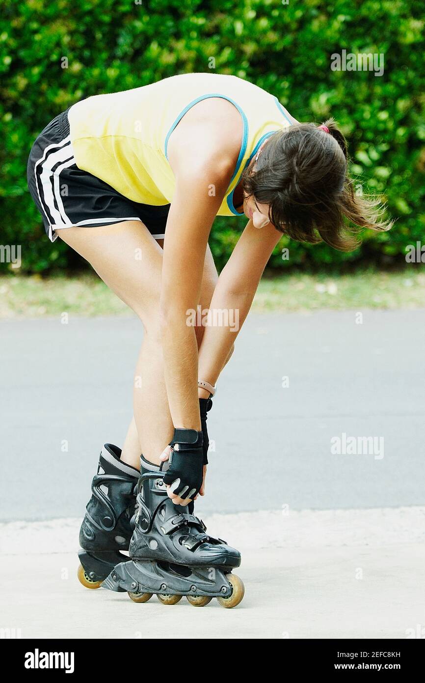 Mid adult woman wearing inline skates Stock Photo - Alamy