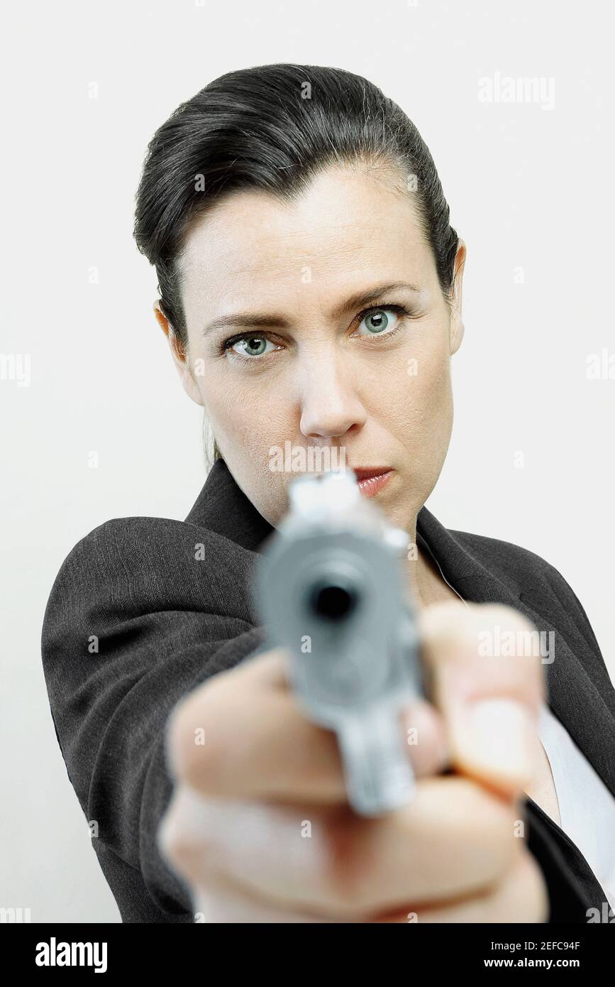 Woman pointing a gun at the camera hi-res stock photography and images ...
