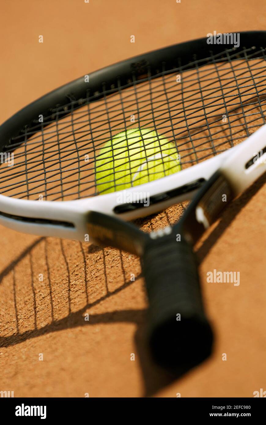 Close-up of a tennis racket on a tennis ball Stock Photo - Alamy
