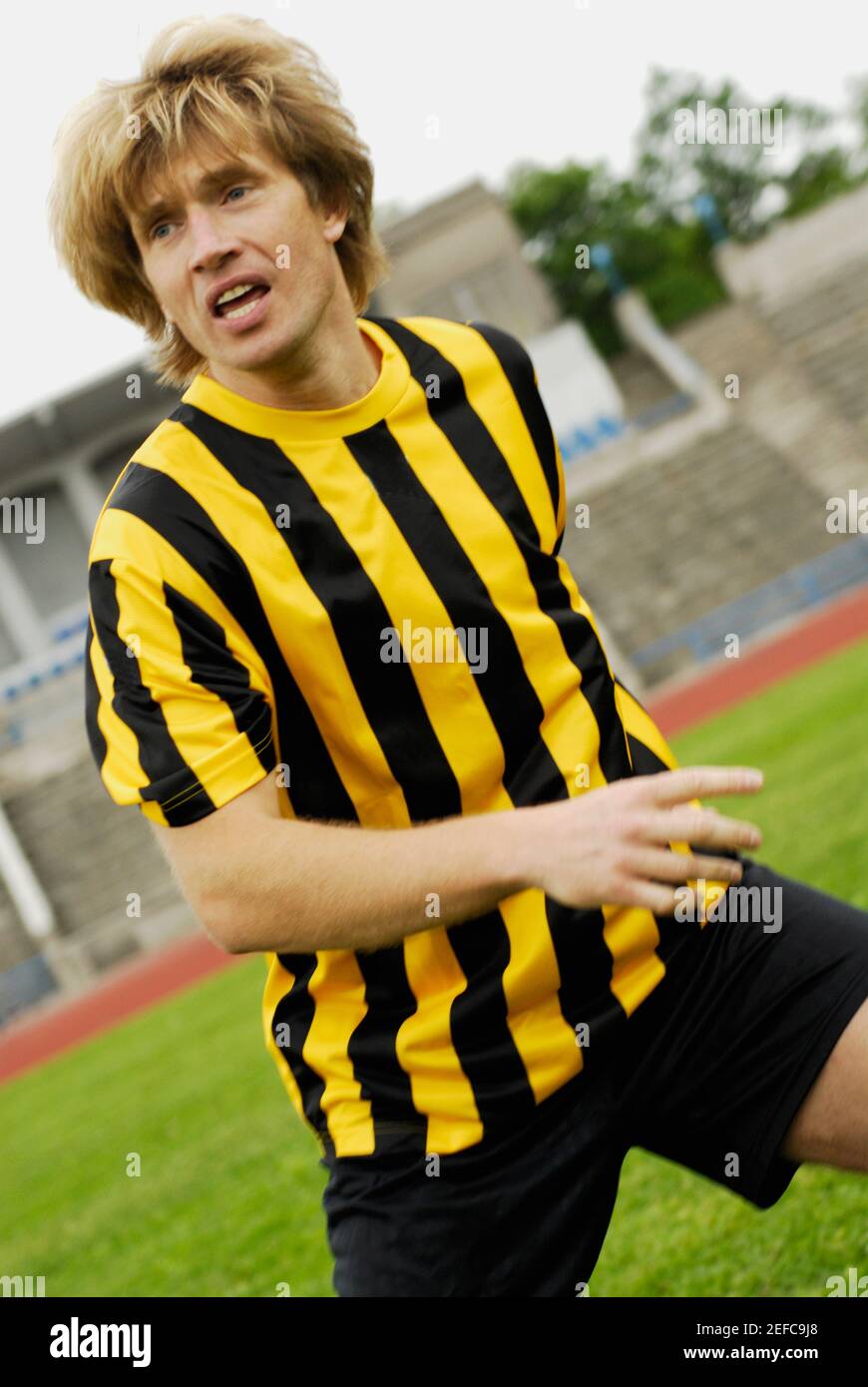 Close-up of a soccer player running in a soccer field Stock Photo - Alamy