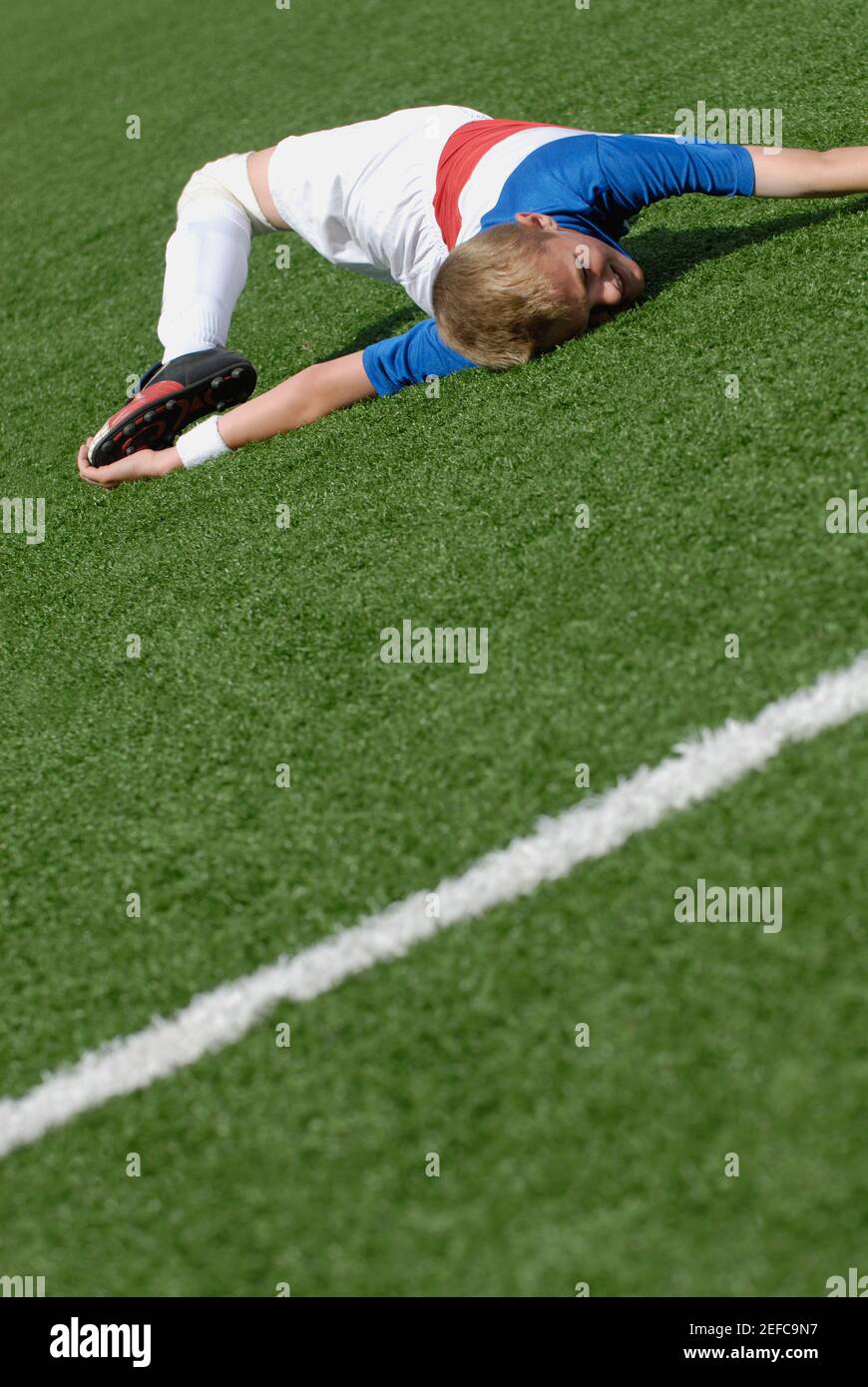 Soccer boy stretching hi-res stock photography and images - Alamy