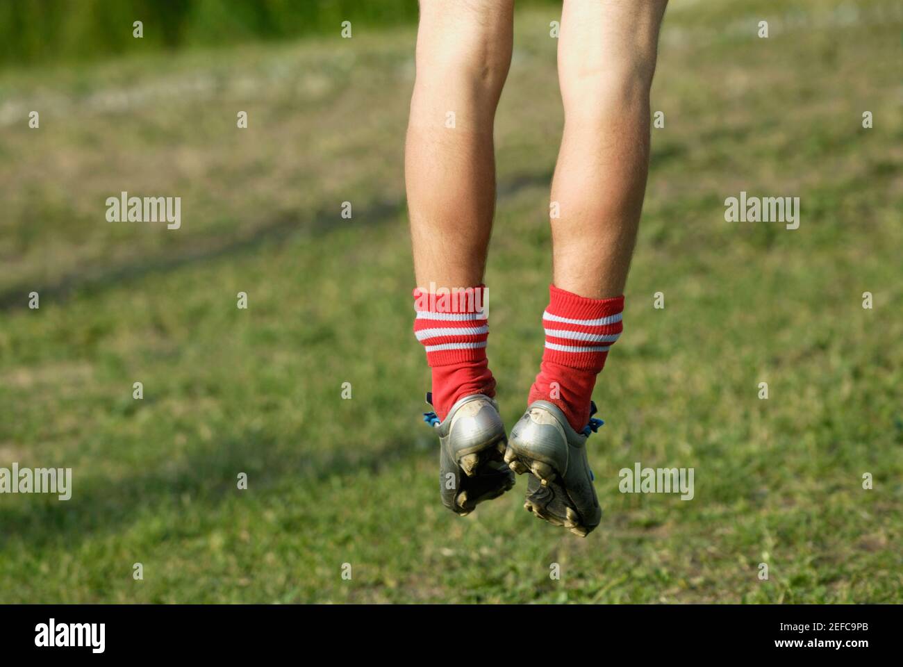Low section view of a soccer player jumping Stock Photo - Alamy