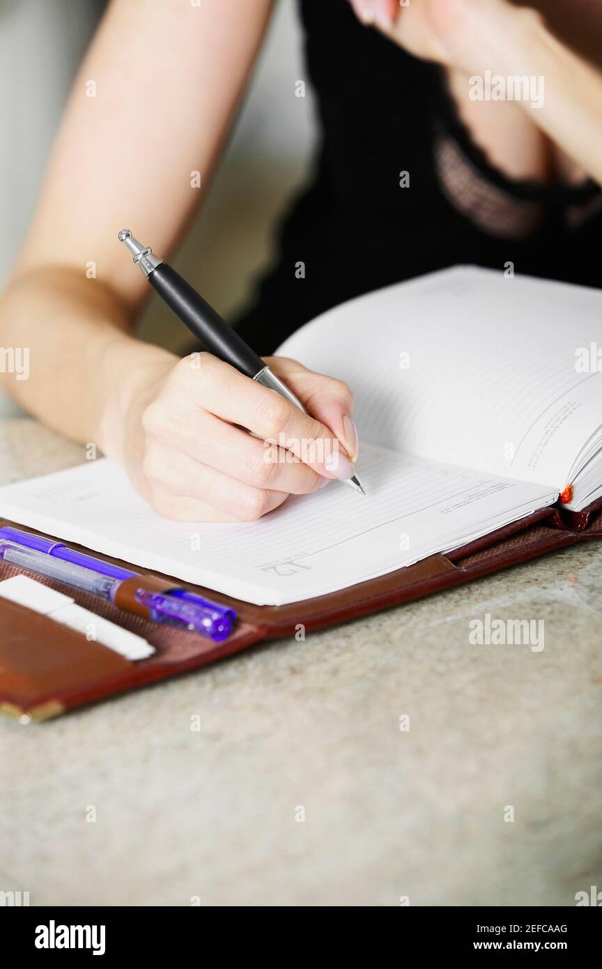 Close up of a womanŽs hand writing in a diary Stock Photo - Alamy