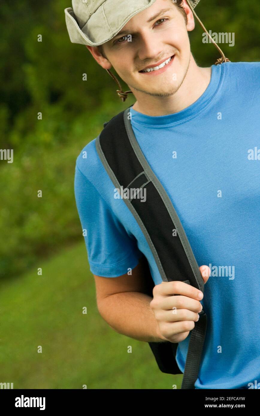 Young man carrying a backpack hi-res stock photography and images - Alamy