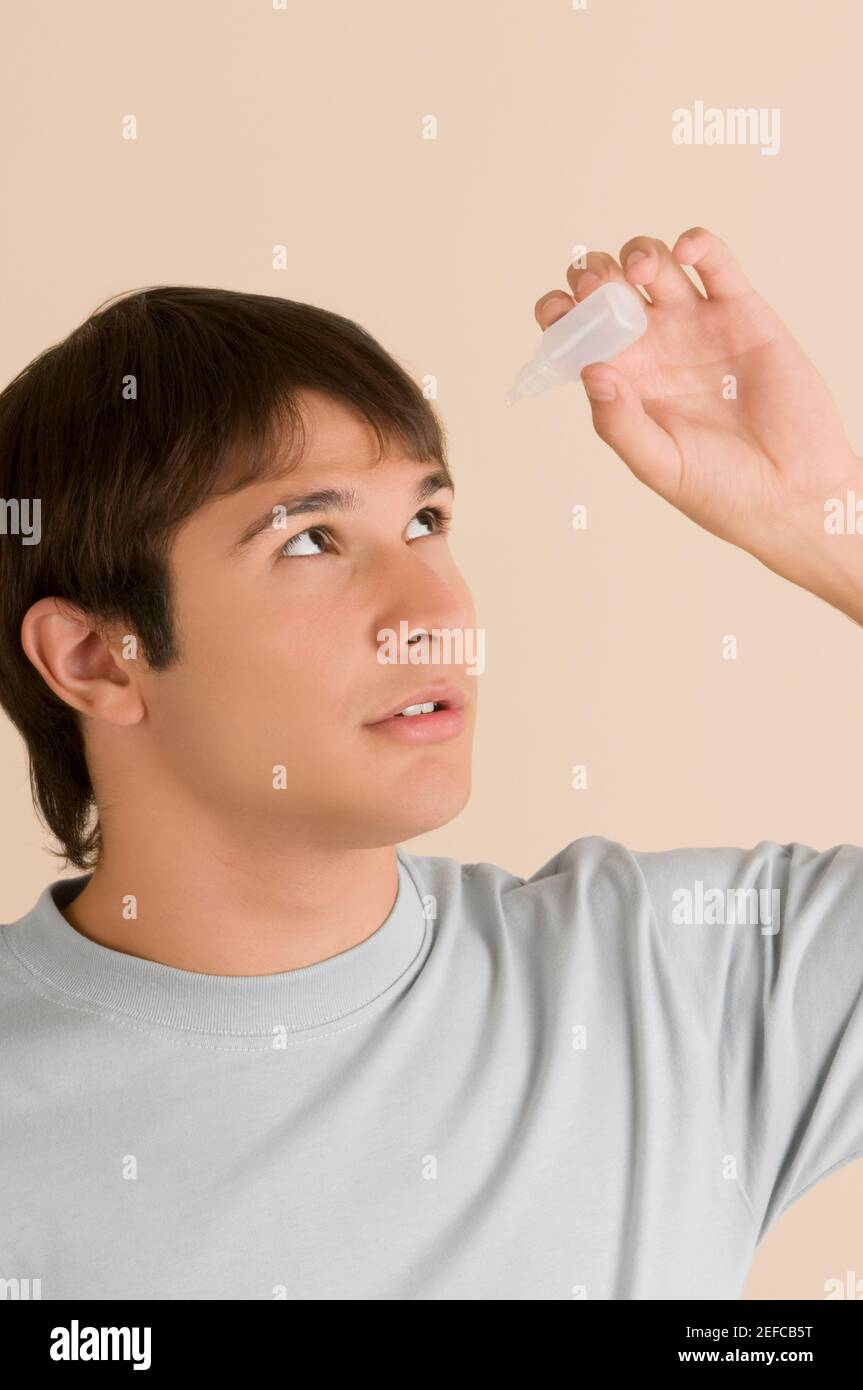 Man putting eye drops in his eyes hi-res stock photography and images ...