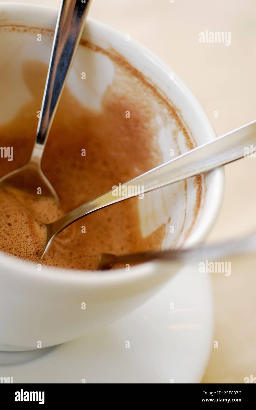Close-up of teaspoons in an empty coffee cup Stock Photo - Alamy