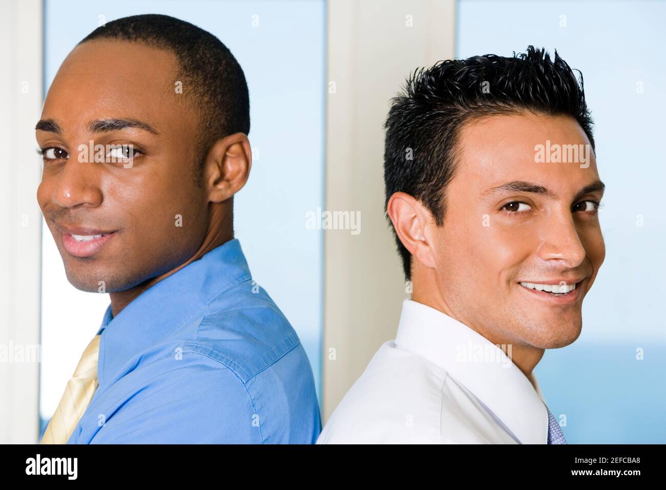 Side profile of two businessmen back to back Stock Photo - Alamy