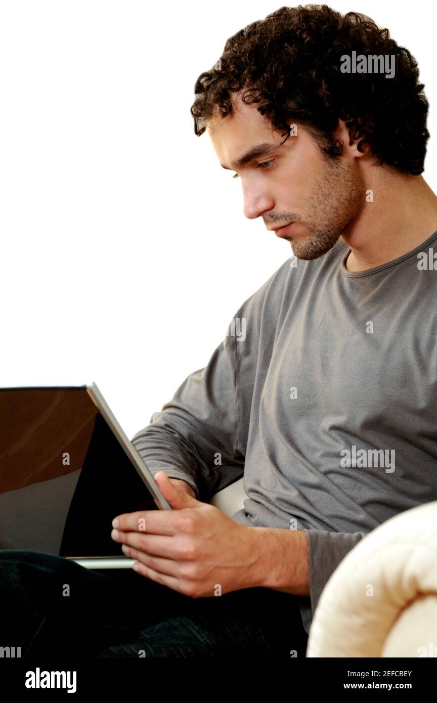 Side profile of a young man using a laptop Stock Photo - Alamy