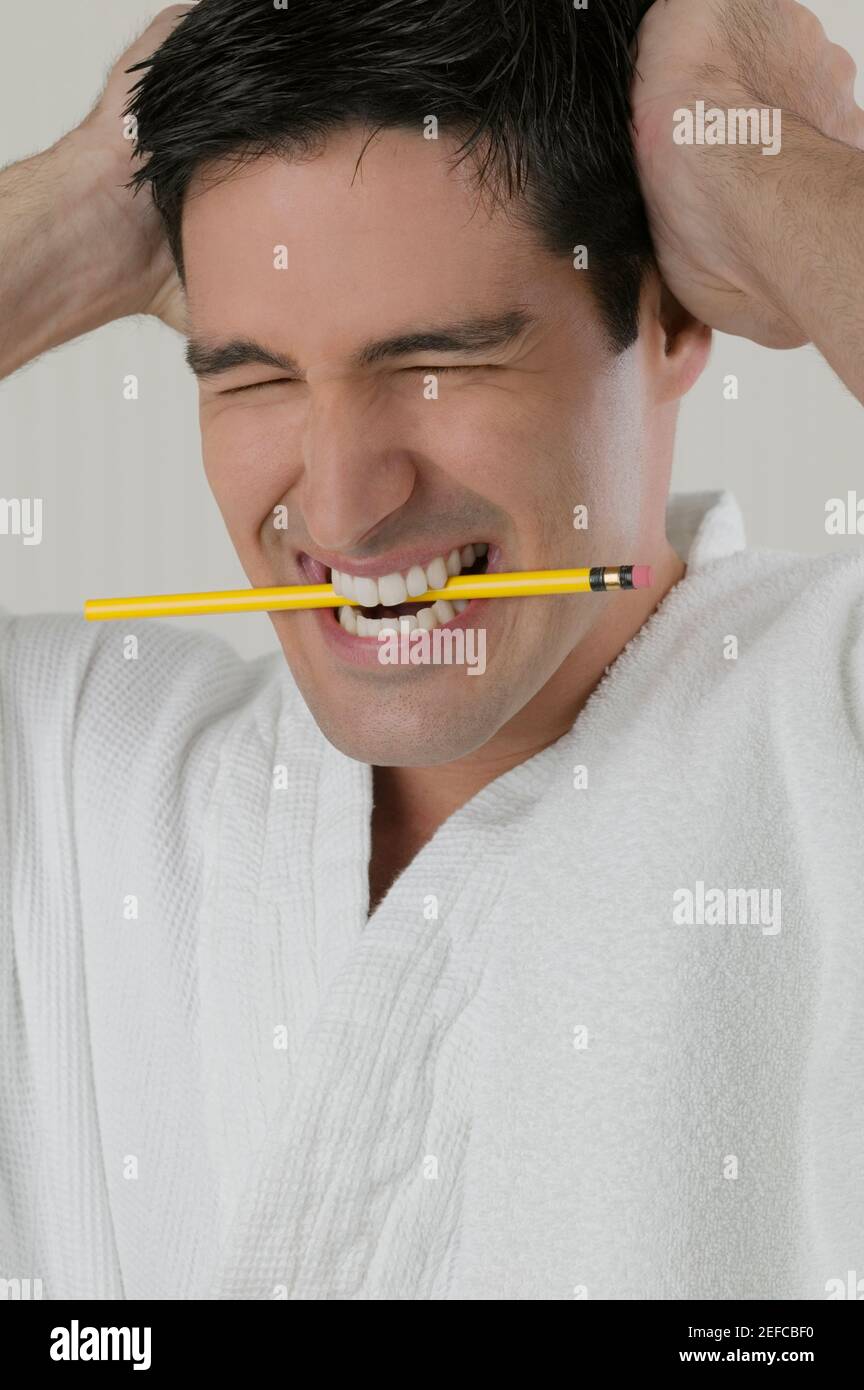 Angry man biting pencil hi-res stock photography and images - Alamy