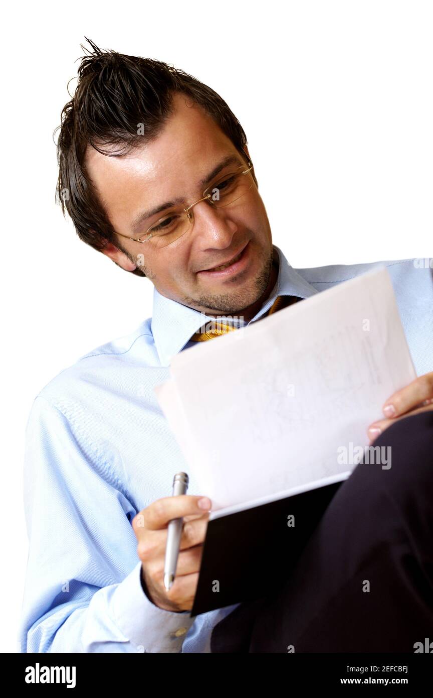 Thoughtful executive holding documents hi-res stock photography and ...