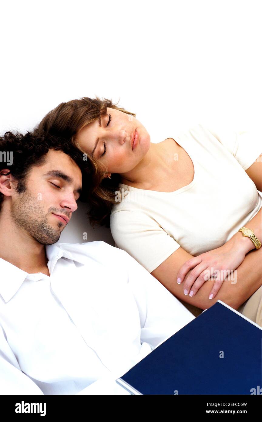 High angle view of a young couple sleeping against a wall Stock Photo ...