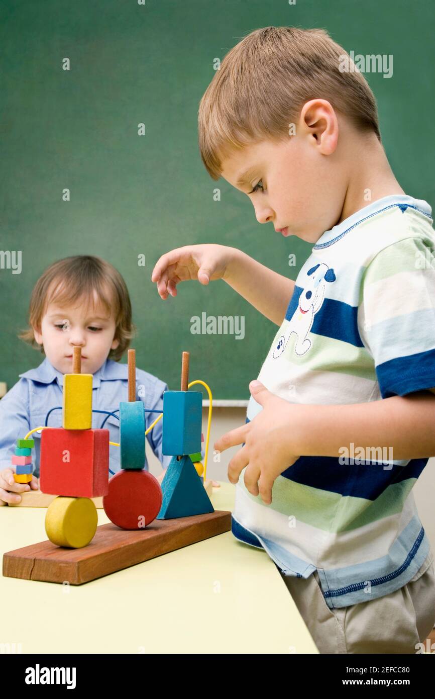 Two boys playing with toys Stock Photo - Alamy