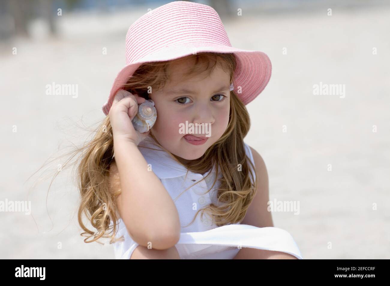 Girl listening to seashell hi-res stock photography and images - Alamy