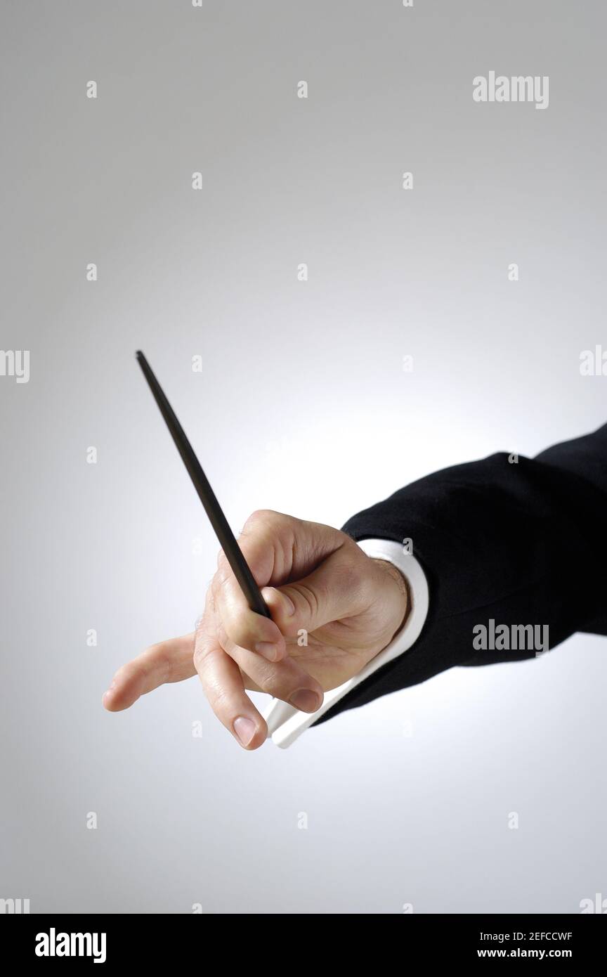Human hand holding baton hi-res stock photography and images - Alamy
