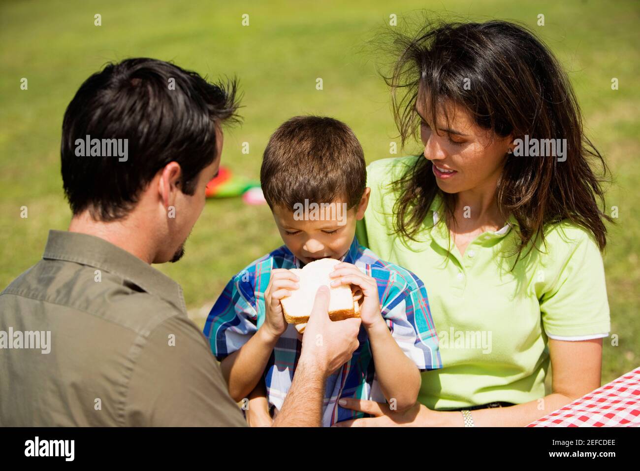 Father feeding bread to his son Stock Photo - Alamy