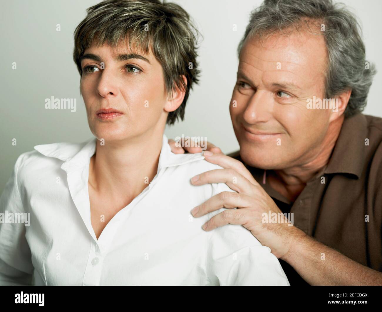 Close-up of a mature man convincing his wife Stock Photo - Alamy