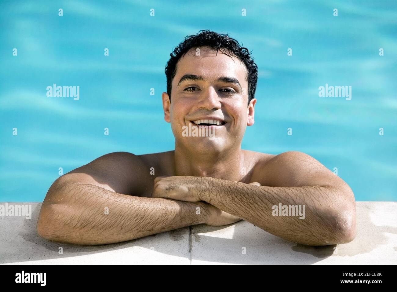 Portrait of a young man smiling in a swimming pool Stock Photo - Alamy