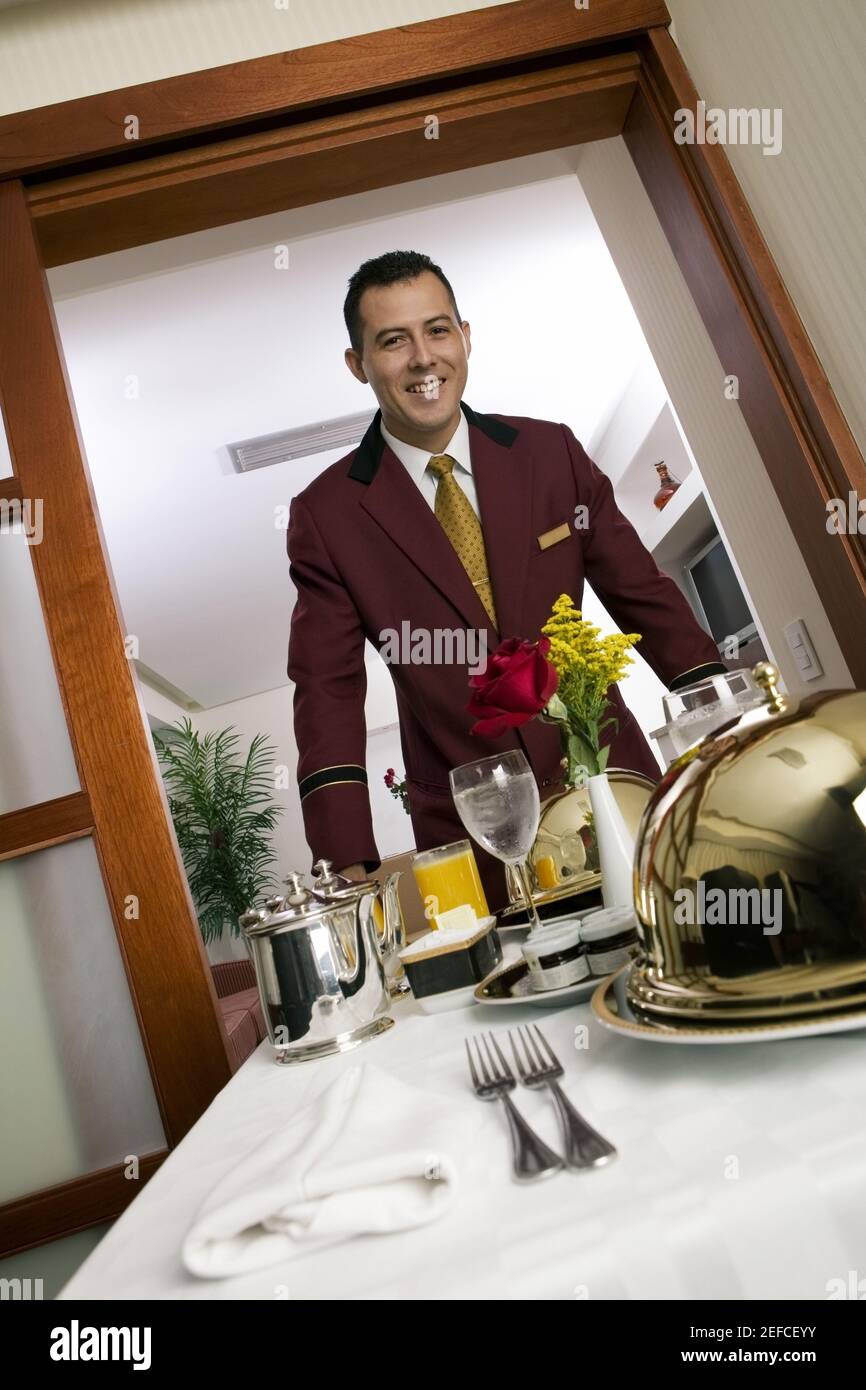Portrait of a waiter serving food Stock Photo - Alamy