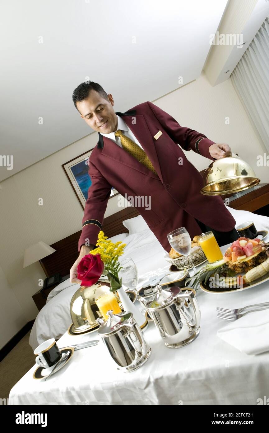 Waiter serving food Stock Photo - Alamy