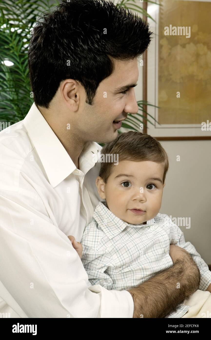 Side profile of a father holding his son Stock Photo - Alamy