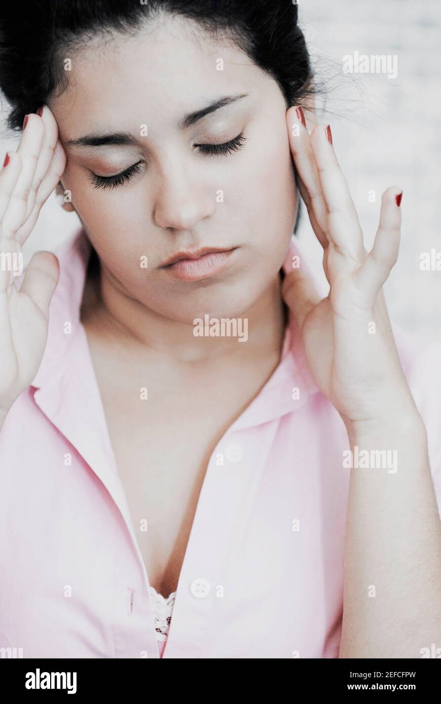 One woman rubbing temples hi-res stock photography and images - Alamy