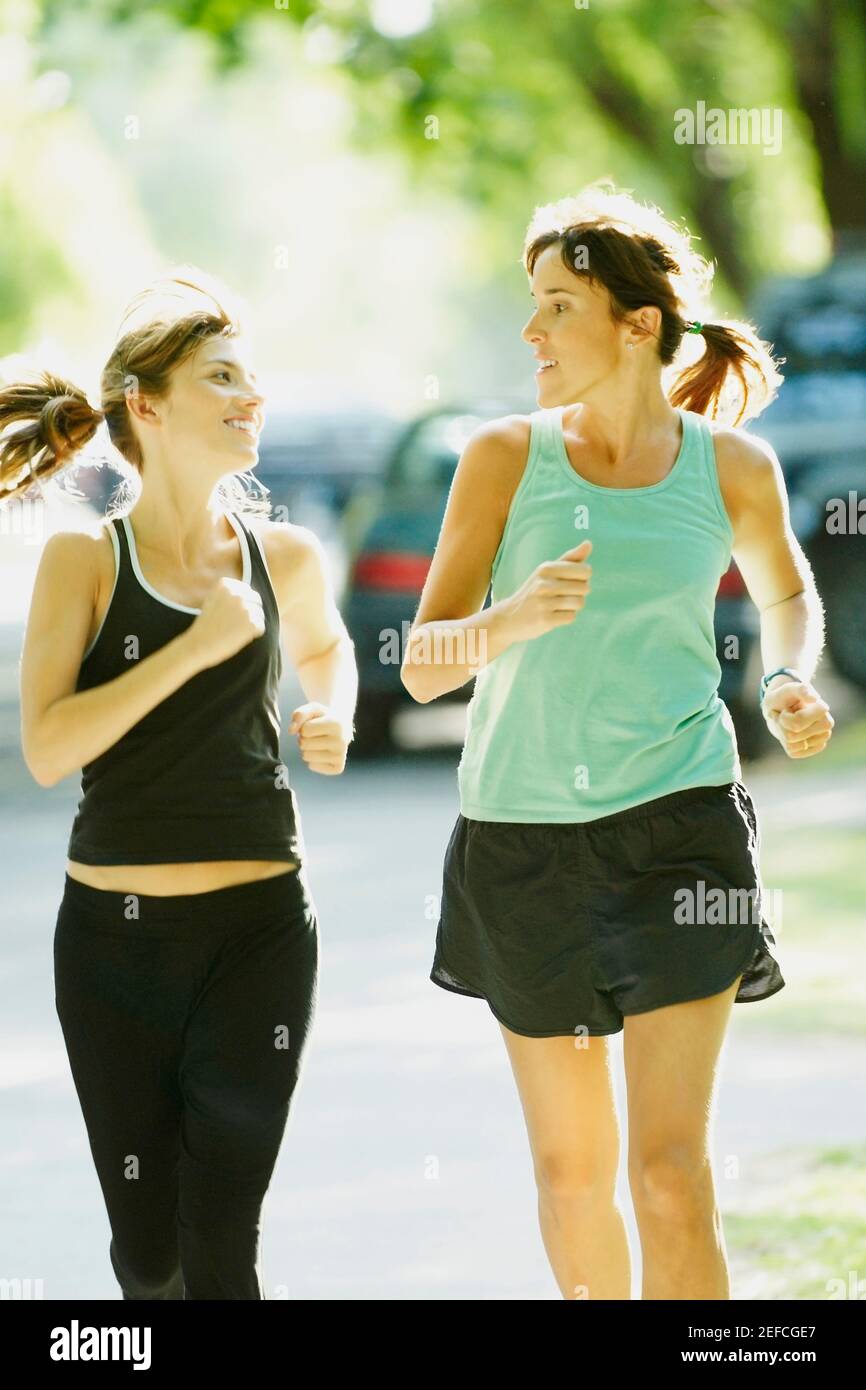Two women jogging on the road Stock Photo - Alamy