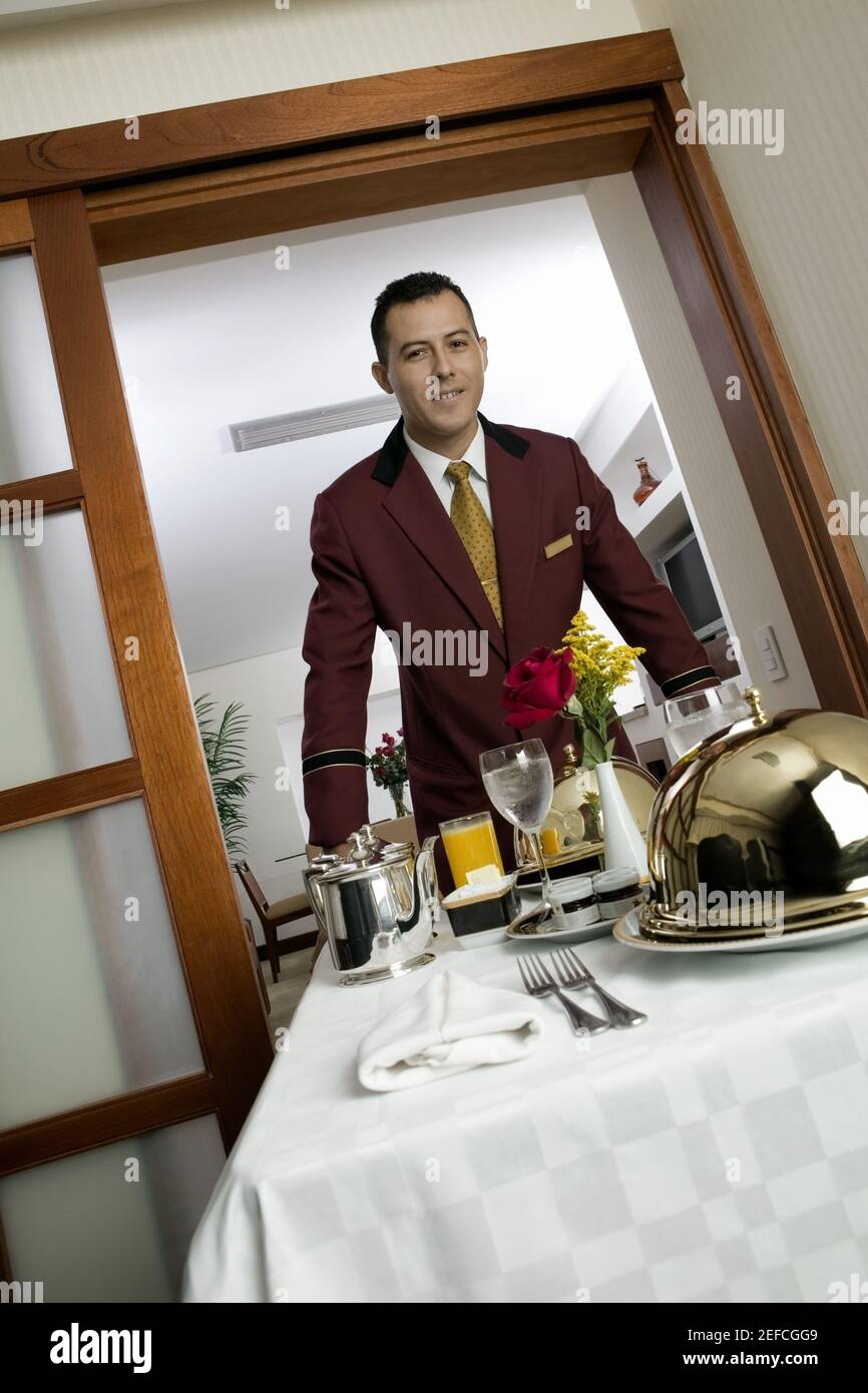 Portrait of a waiter serving food Stock Photo - Alamy