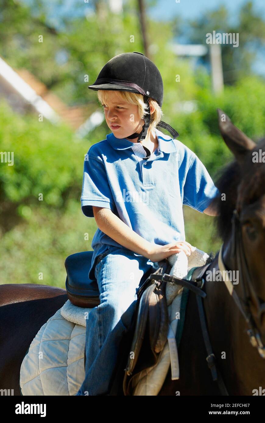 Boy horseback riding Stock Photo - Alamy