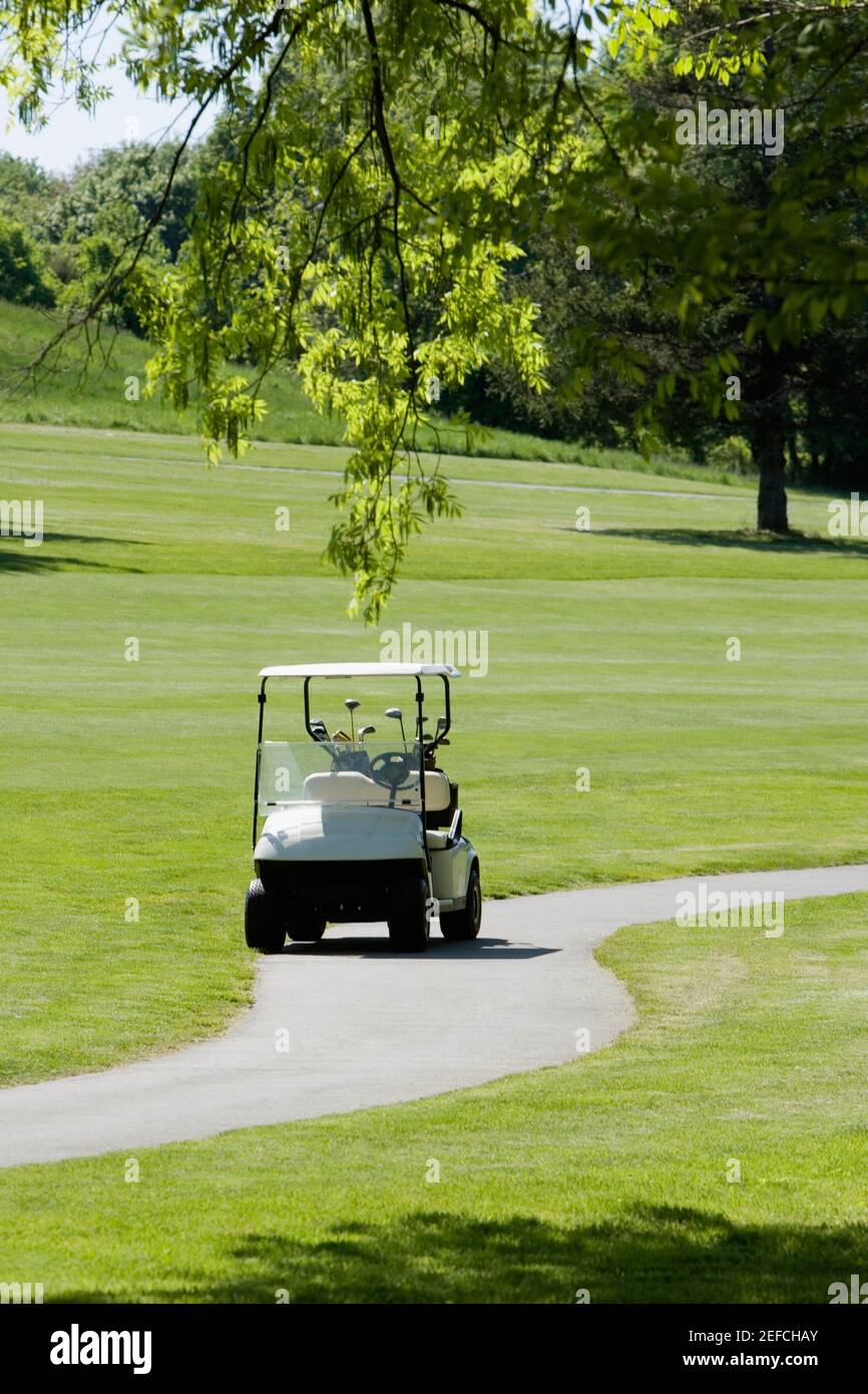 Golf cart on a path in a golf course Stock Photo - Alamy