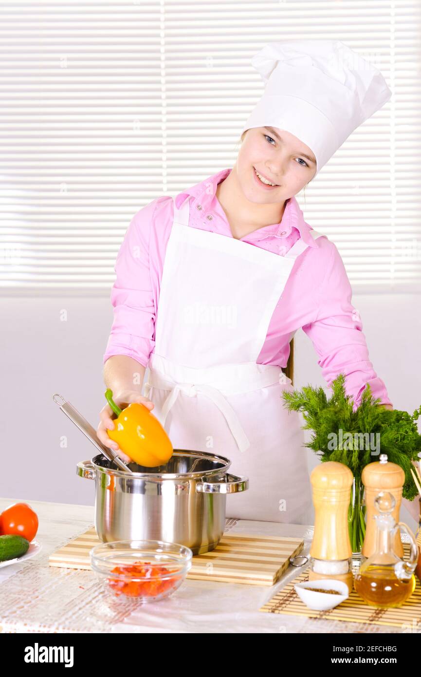 Portrait of beautiful girl wearing chef uniform cooking Stock Photo - Alamy