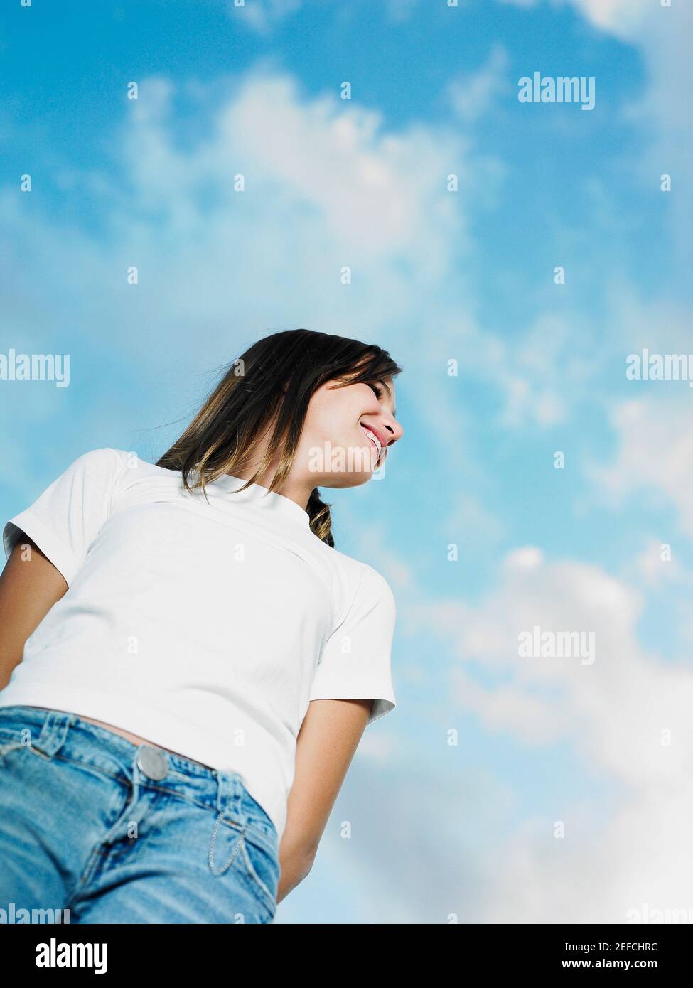 Low angle view of a teenage girl looking sideways Stock Photo - Alamy