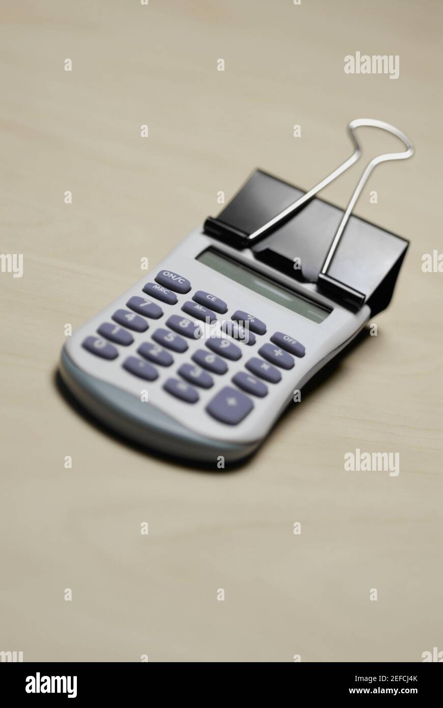Close up of a calculator and a paper clip Stock Photo - Alamy