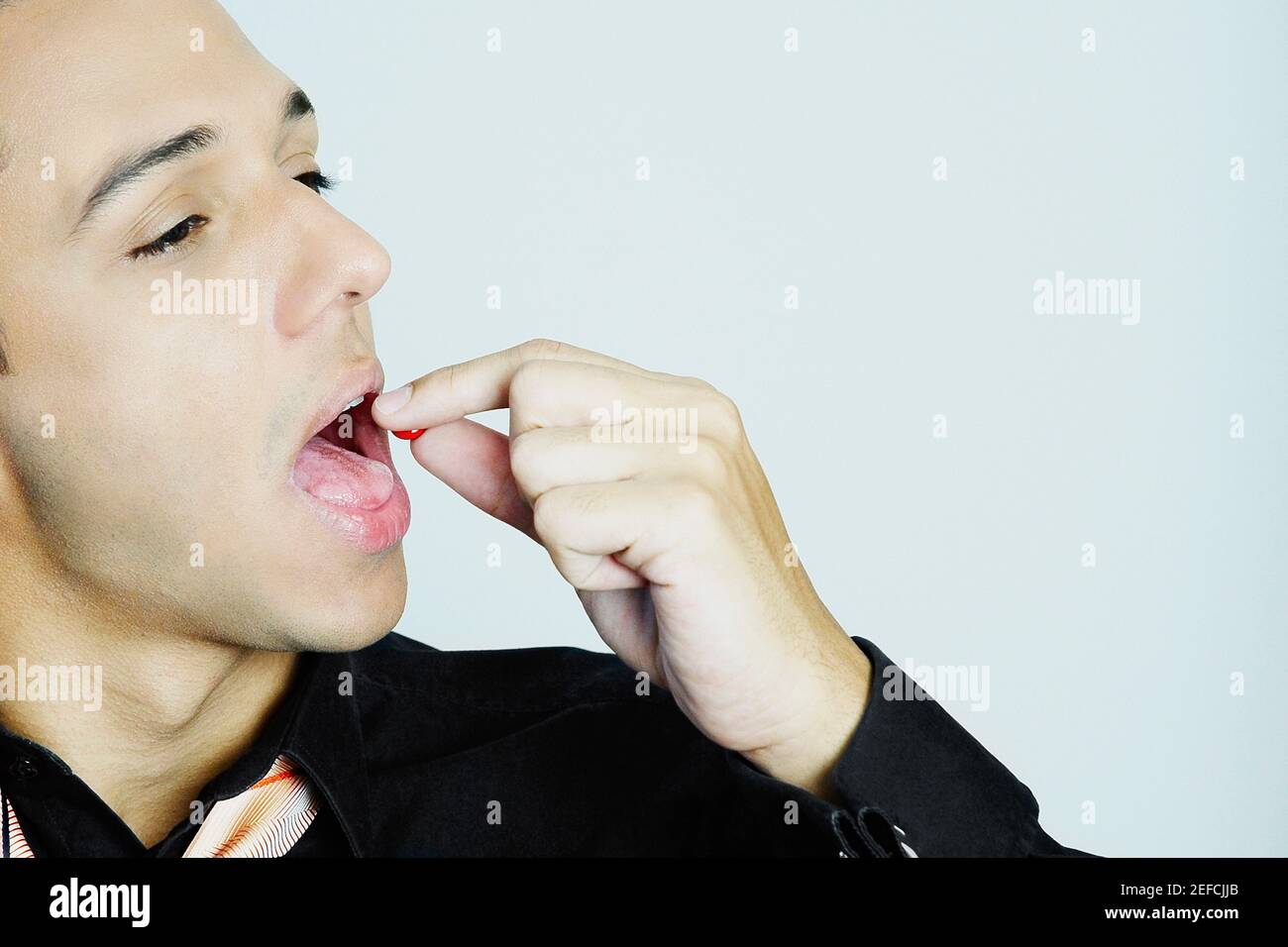 Man eating pill hi-res stock photography and images - Alamy