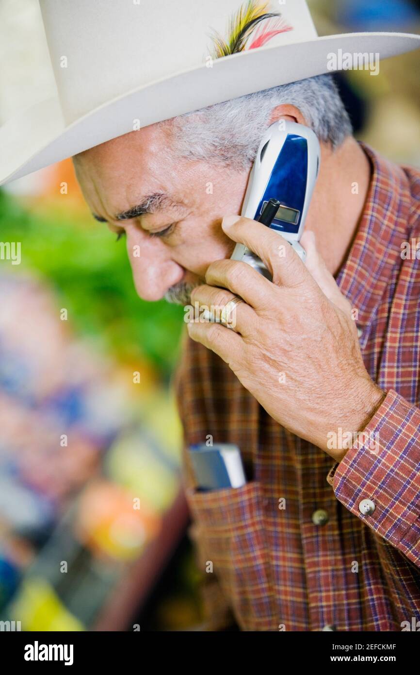 Side profile of a senior man talking on a mobile phone Stock Photo - Alamy