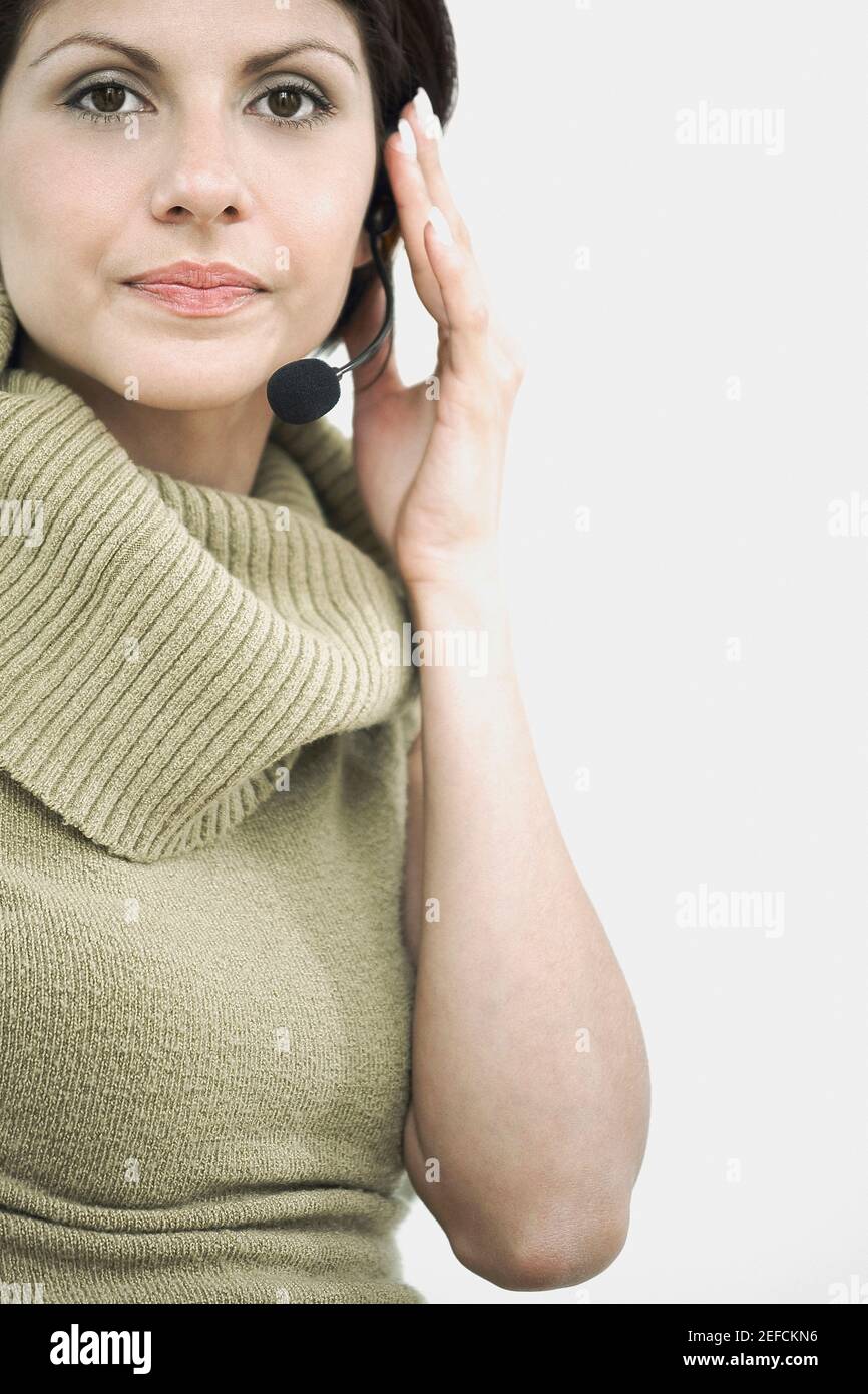 Portrait of a young woman using a headset Stock Photo - Alamy