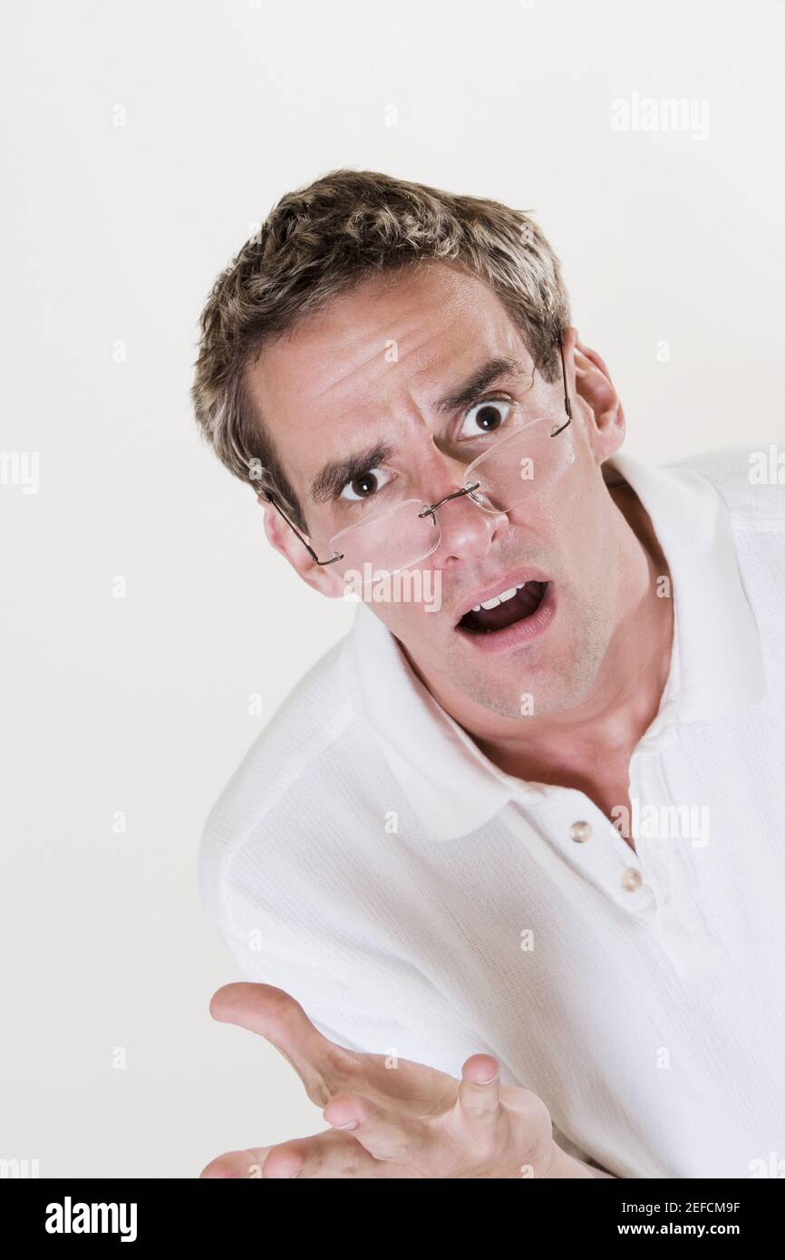 Portrait of a young man looking shocked Stock Photo - Alamy