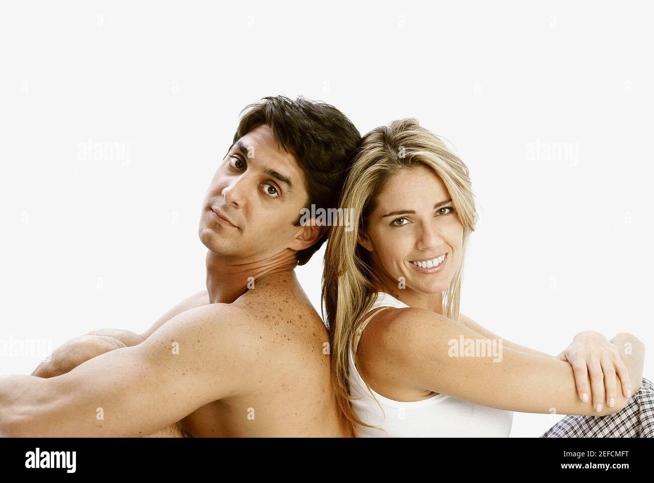 Portrait of a mid adult couple sitting back to back and smiling Stock ...